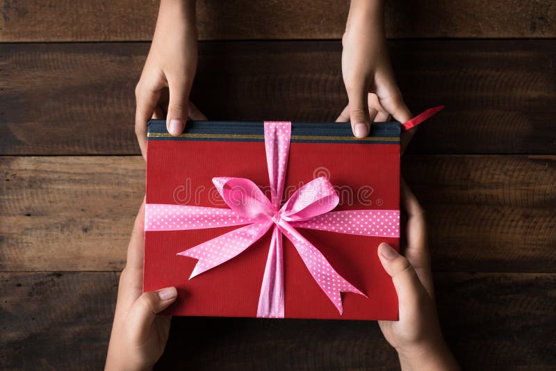 Giving a book as a present stock photo. Image of decor - 106638402