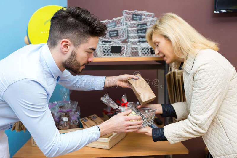 Giving Extra Free Chocolate Sample To Client Stock Image - Image of ...