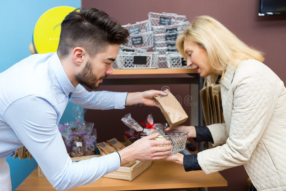 Giving Extra Free Chocolate Sample To Client Stock Image - Image of ...