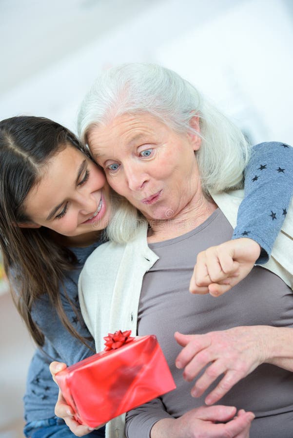 Giving grandma a gift stock image. Image of birthday - 120360465