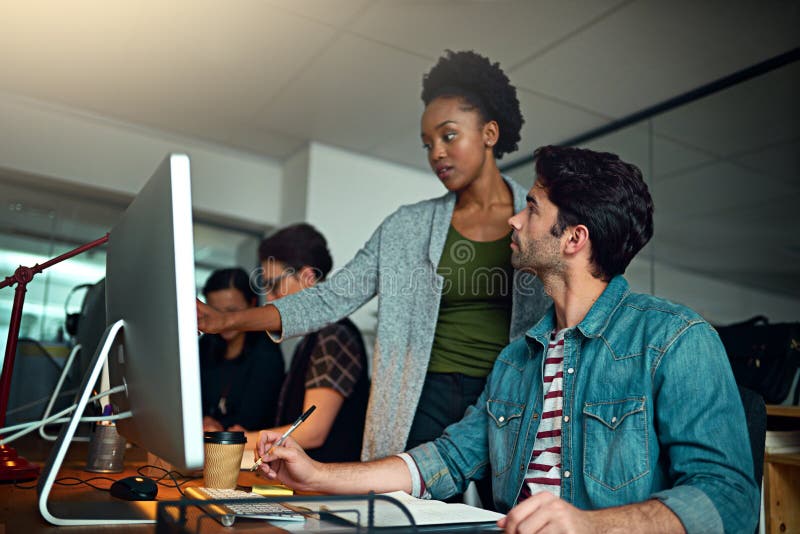 Giving Her Expert Input. Two Young Designers Working in the Office ...