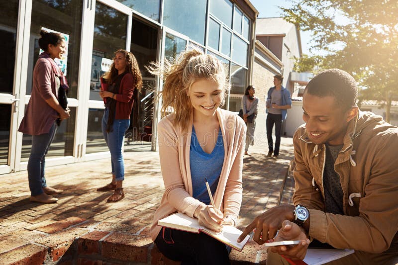 Giving Her a Few Study Tips. Two Students Studying Together on Campus ...