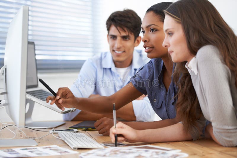 Giving Her Input. Three Young Colleagues Working at a Desk. Stock Photo ...