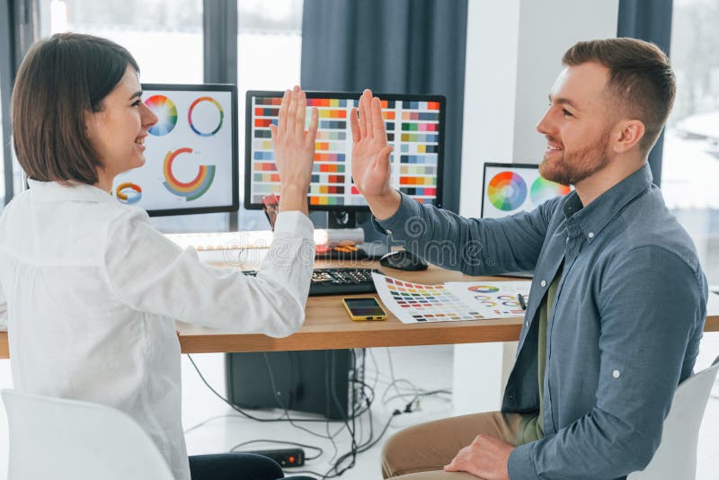 Giving High Five. Two Designers Working Together in the Office Stock ...