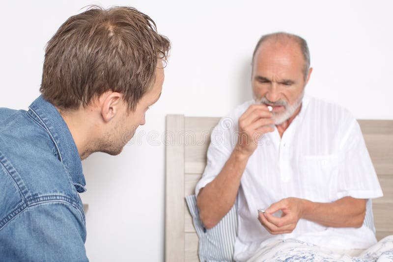 Giving Medication To an Elderly Man Stock Photo - Image of parent ...