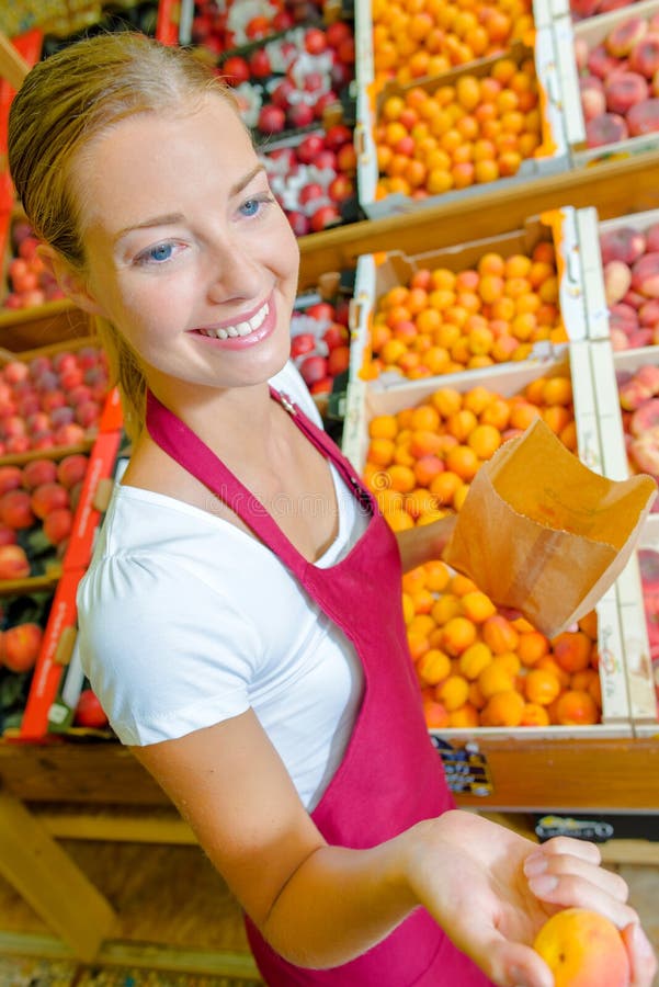 Giving orange to customer stock image. Image of counter - 101435991