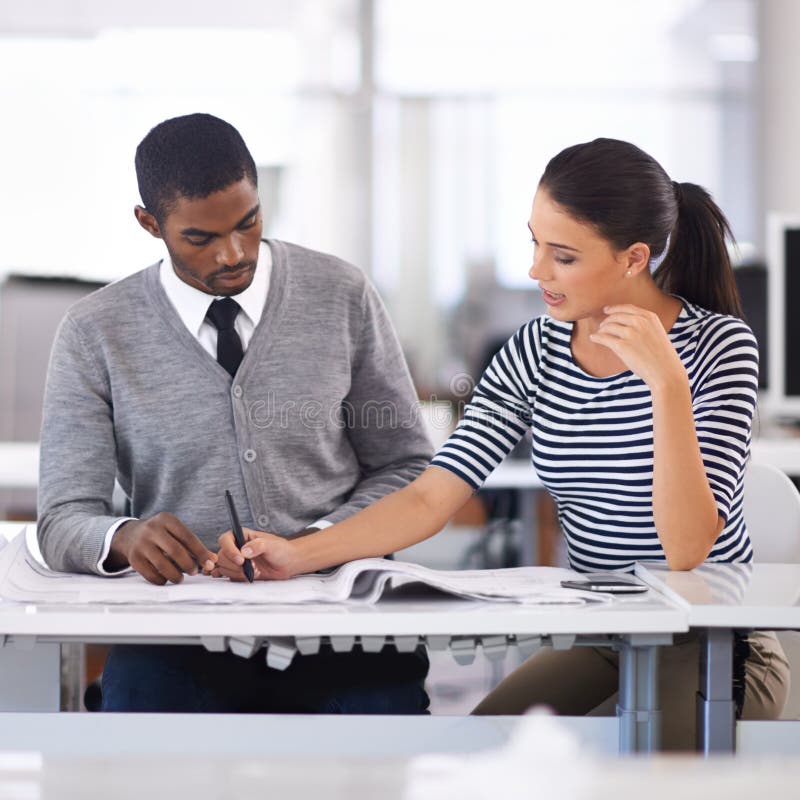 Giving the Plans a Once Over. Two Colleagues Working Together in the ...