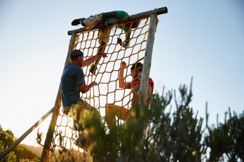 Giving it Their All. a Group of Men Going through an Obstacle Course at ...