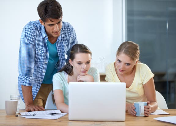 Giving Their Input. Three Colleagues Working in an Office. Stock Photo ...