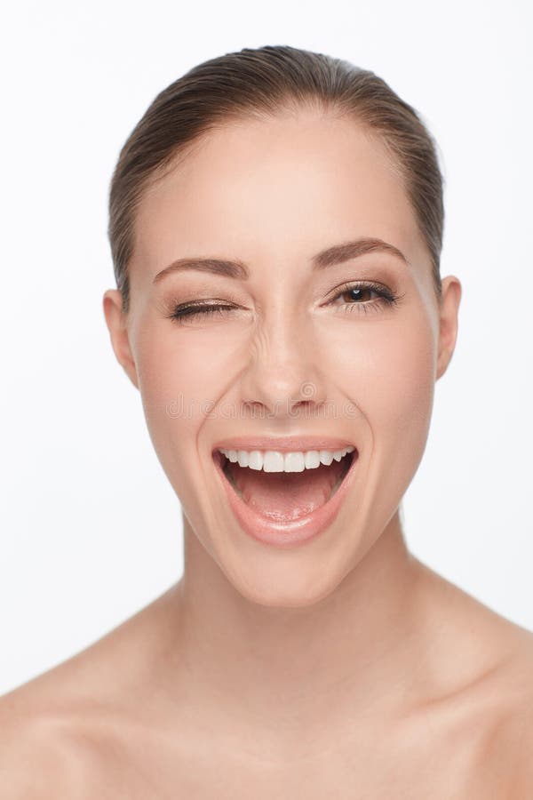 Giving You A Wink A Beautiful Young Woman Winking Playfully At The