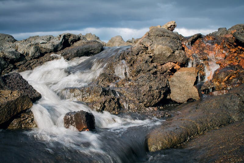 Glacial Water Flowing through Lava Stones Stock Photo - Image of river ...