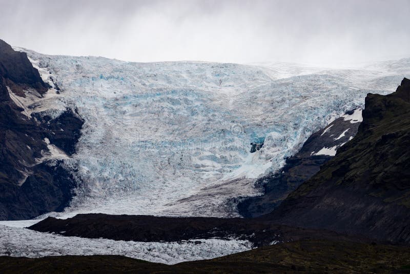 Glacier with Ash in the Ice with Melted Water and Icelandic Landscape ...