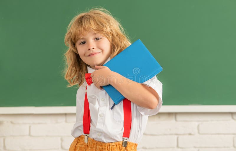 Glad Child Boy in Bow Tie Study in School Classrrom with Notebook ...