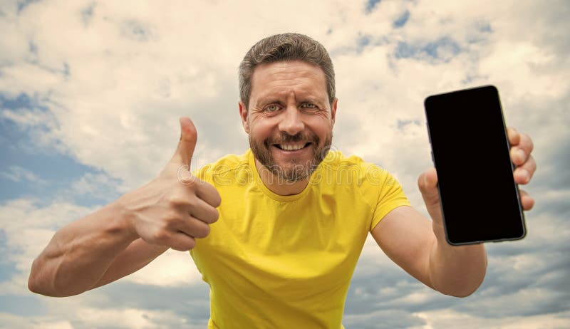 Glad Man Presenting Screen of Smartphone with Copy Space Stock Photo ...
