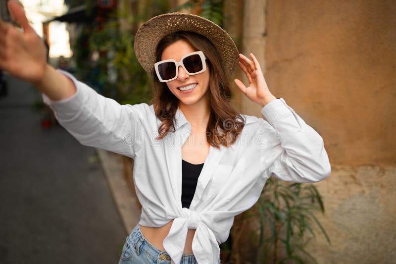 Glad Smiling Millennial European Female Tourist In Hat And Sunglasses