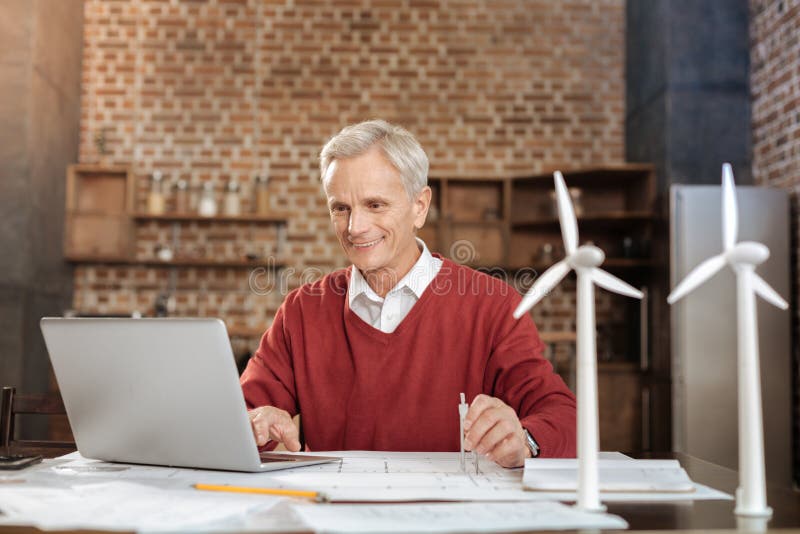 Cheerful Senior Engineer Working on Laptop Stock Image - Image of ...