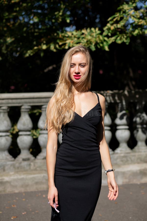 Glamorous Blonde Model With Long Hair And Red Lips Wearing Black Stock