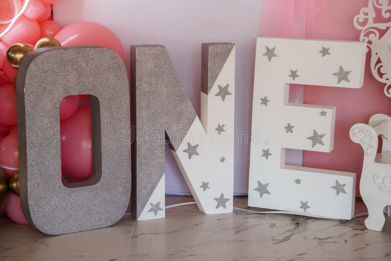 A Glamorous First Birthday Celebration Backdrop Featuring Large ...