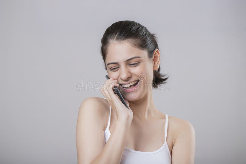 A Glamorous Woman Smiling while Talking on the Phone Stock Photo ...