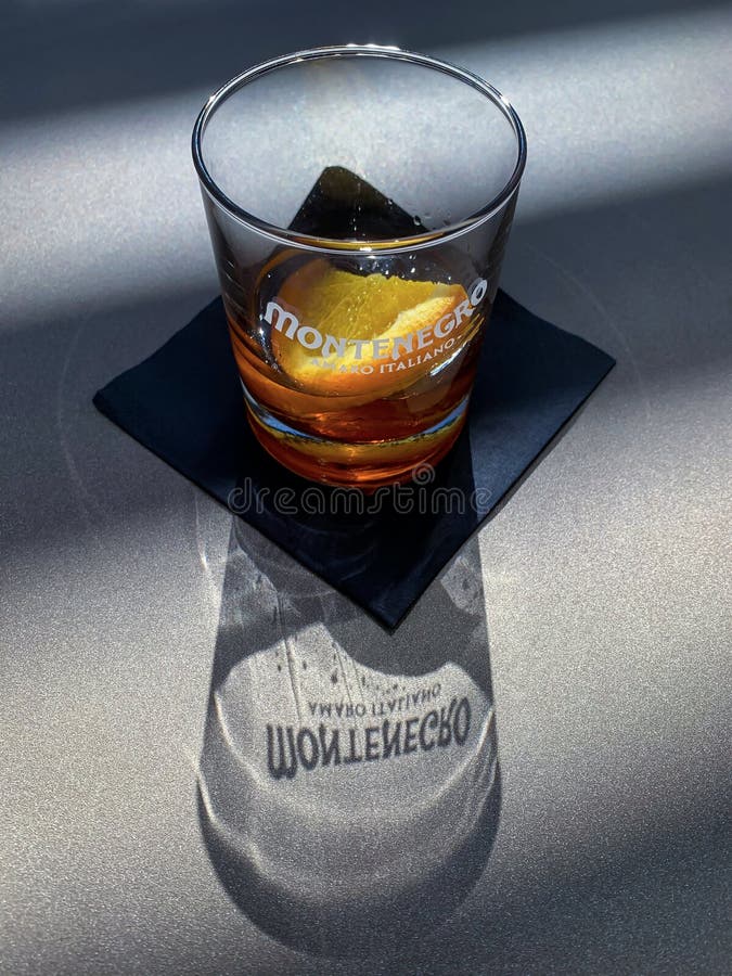 Glass with Amaro Montenegro and with Shadow on a Table in Italy ...