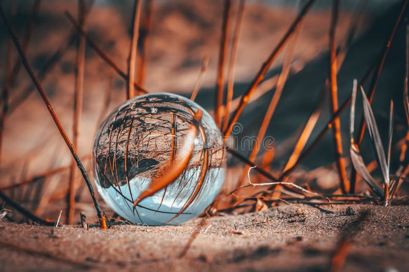 Glass Ball Laying on the Sand Stock Photo - Image of sunset, reflection ...