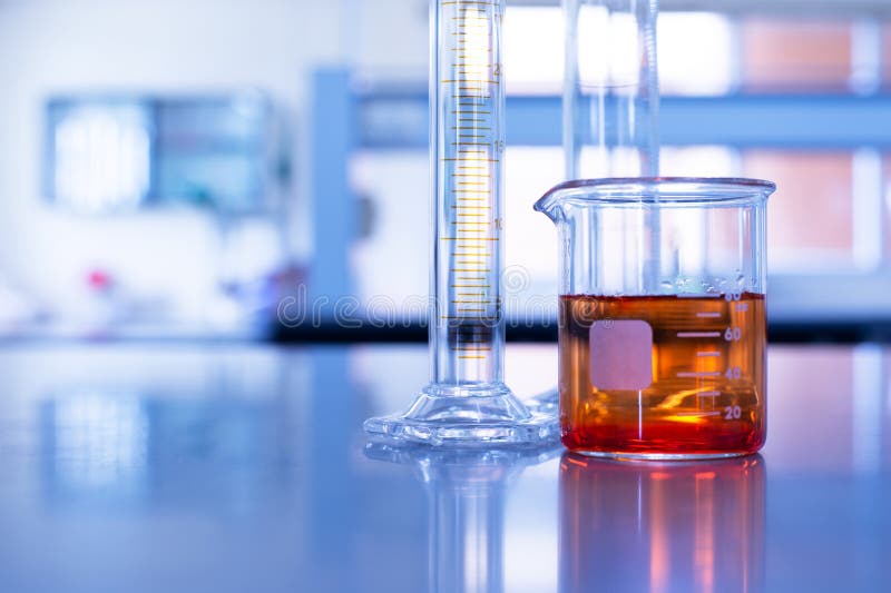 Orange Solution in Science Glass Flask in Blue Chemistry School ...