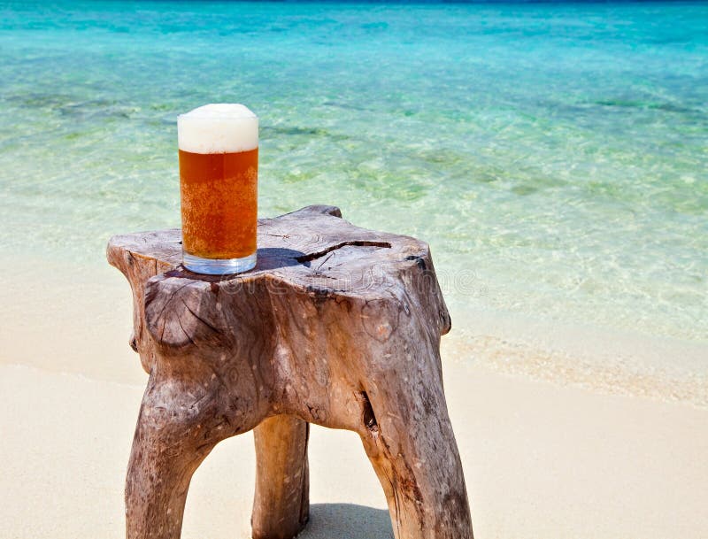 Glass of beer on a beach stock photo. Image of stool - 17009036