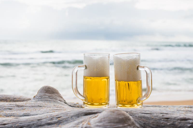 Glass of beer on a sunset stock image. Image of sand - 85585291