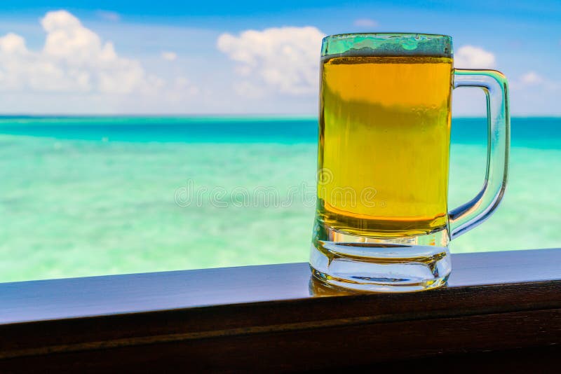 A Glass of Beer with Beautiful Tropical Maldives Island . Stock Image ...
