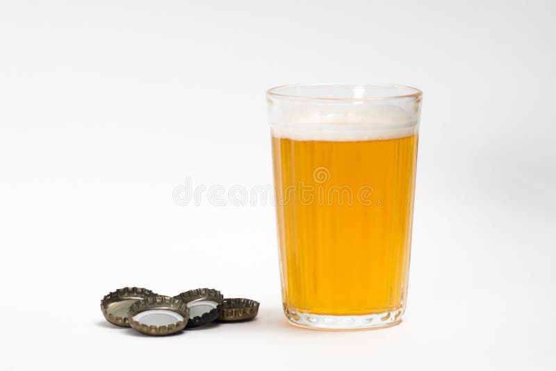 Glass with Beer and Bottle Caps Stock Image - Image of brewed, closeup ...