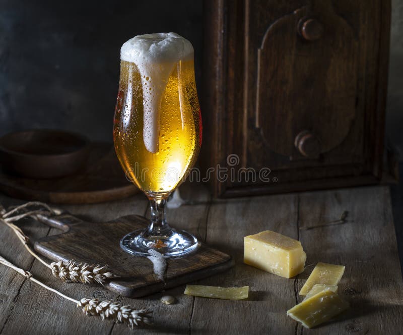 Glass of Beer on a Rustic Table Stock Photo - Image of tableware ...