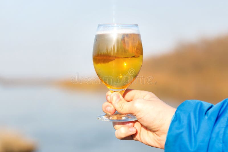Glass of beer in hand. stock image. Image of bright, hand - 88360199