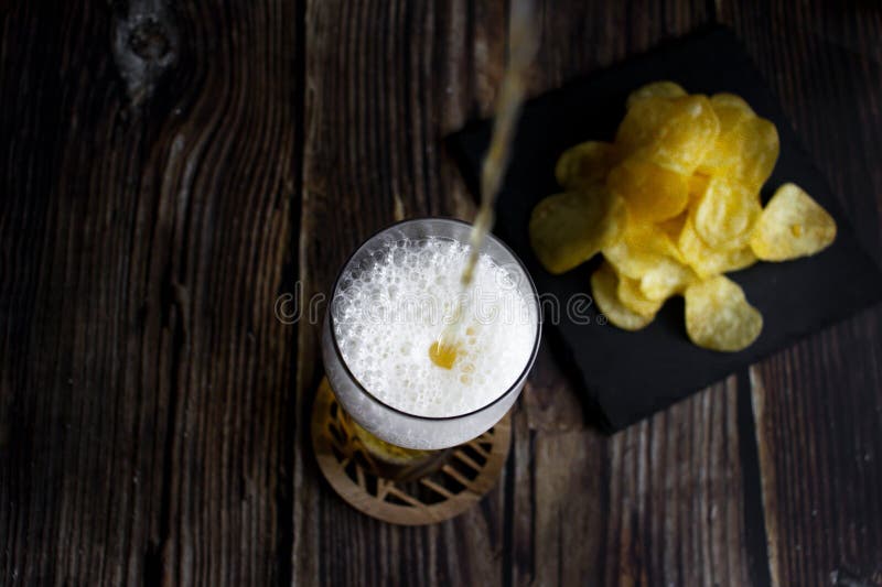 A Glass of Beer and Potato Chips. on a Dark Background. Alcoholic Drink ...