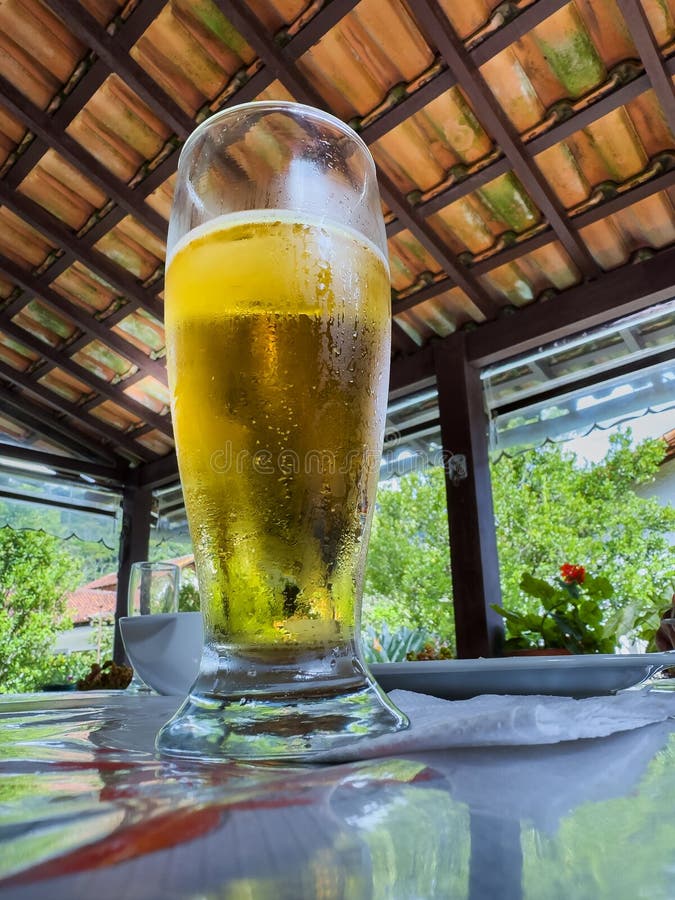 A Glass of Beer on a Restaurant Table. Stock Image - Image of plant ...