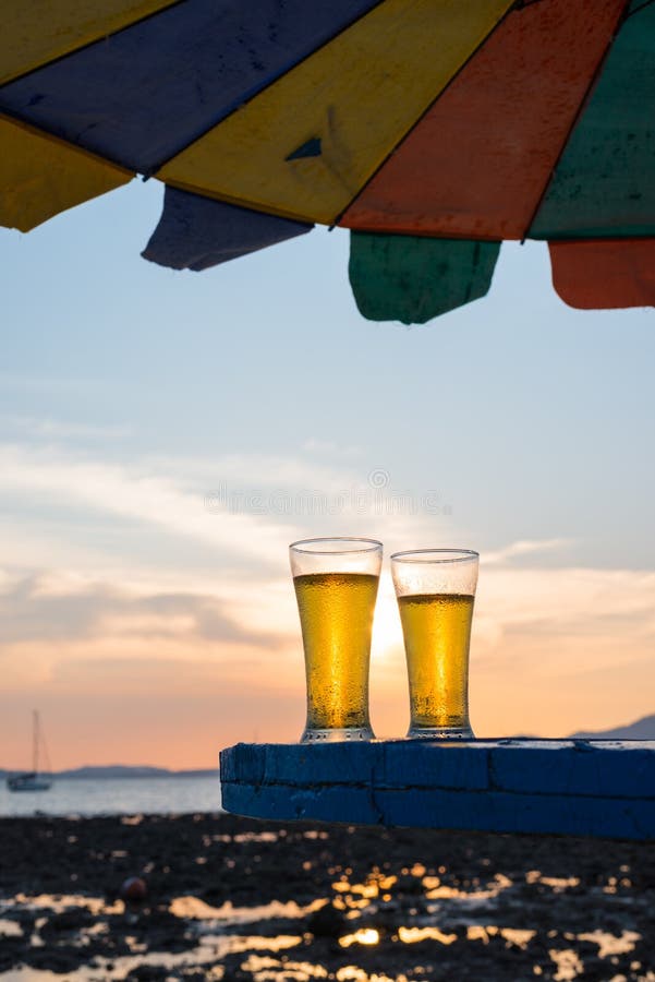 Glass of beer on a sunset stock image. Image of closeup - 90985731