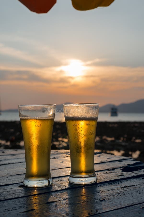 Glass of beer on a sunset stock photo. Image of glass - 95540114