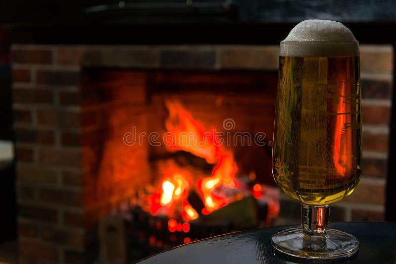 Glass of Beer on a Table with a Burning Log Fire Stock Photo - Image of ...