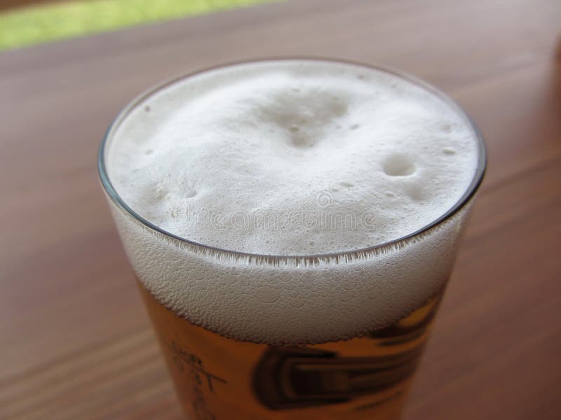Glass of Beer on the Table . Beer Foam Closeup Stock Image - Image of ...