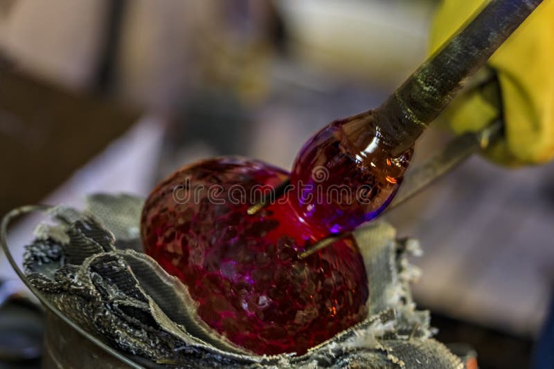 Glass Blower Shaping a Bubble of Melted Glass on a Rod by Hand at a ...