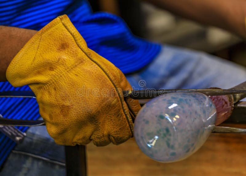 Glass Blower Shaping a Bubble of Melted Glass on a Rod by Hand at a ...
