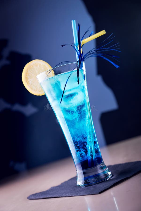 Glass of Blue Alcoholic Cocktail on Dark Blue Background Stock Image ...
