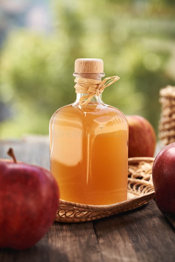 A Glass Bottle of Apple Cider Vinegar with Red Apples Stock Image ...