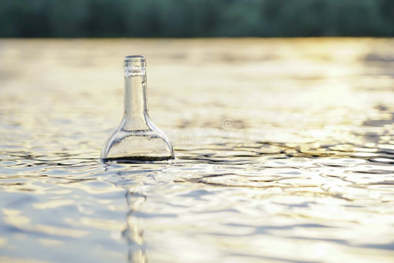 Glass Bottle Floats Adrift in Water Stock Photo - Image of floats ...