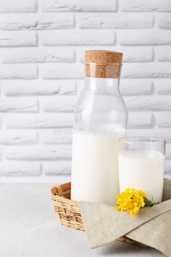 Glass and Bottle of Fresh Milk on Table Against White Brick Wall Stock ...