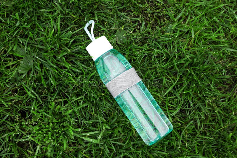 Glass Bottle of Fresh Water on Green Grass, Top View Stock Image ...
