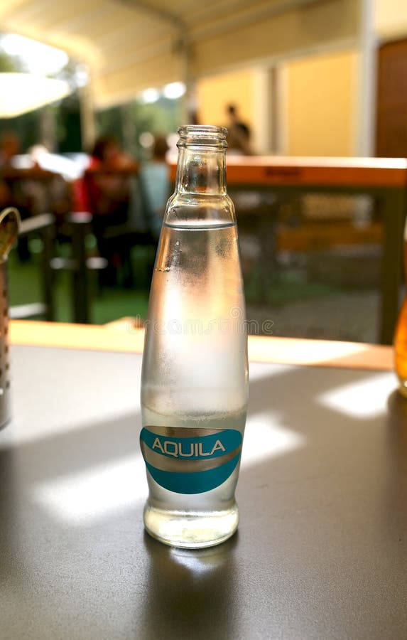A Glass Bottle of Mineral Water Stands on a Table in a Cafe Editorial ...