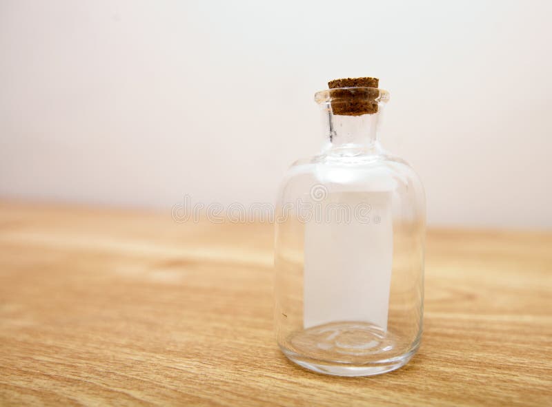 Glass Bottle with Note Inside Stock Photo - Image of furniture, paper ...
