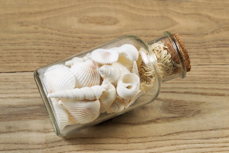 Glass Bottle of Seashells on Rustic Wood Stock Image - Image of boards ...