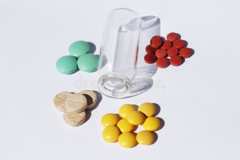 The Glass Bottle for Tablets is Empty, Colored Tablets are Spread ...