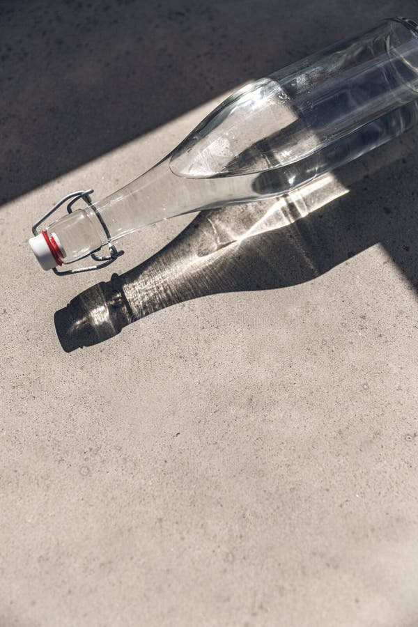 Glass Bottle of Water on Sunny Floor Stock Image - Image of beverage ...